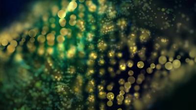 Loop of white little particles fading and moving on 4K dark background ...