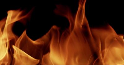 Close up to dynamic flames creating a firewall on dark background in 4K ...