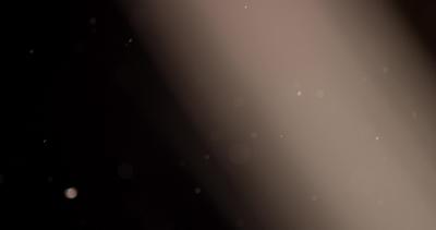 Bright golden particles glowing and floating on dark background in 4K ...