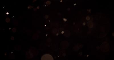 Bright particles floating slowly and desappearing in dark scene in 4K ...