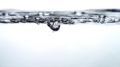 Blue scene of water splashing from left to right, generating waves and ...