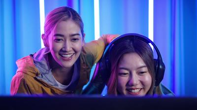 Gamer using lighted up mouse and keyboard playing video game online ...