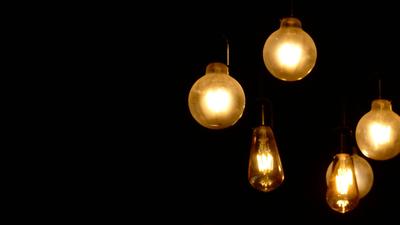 glowing bulb bulbs falling down hanging on string grey background ...